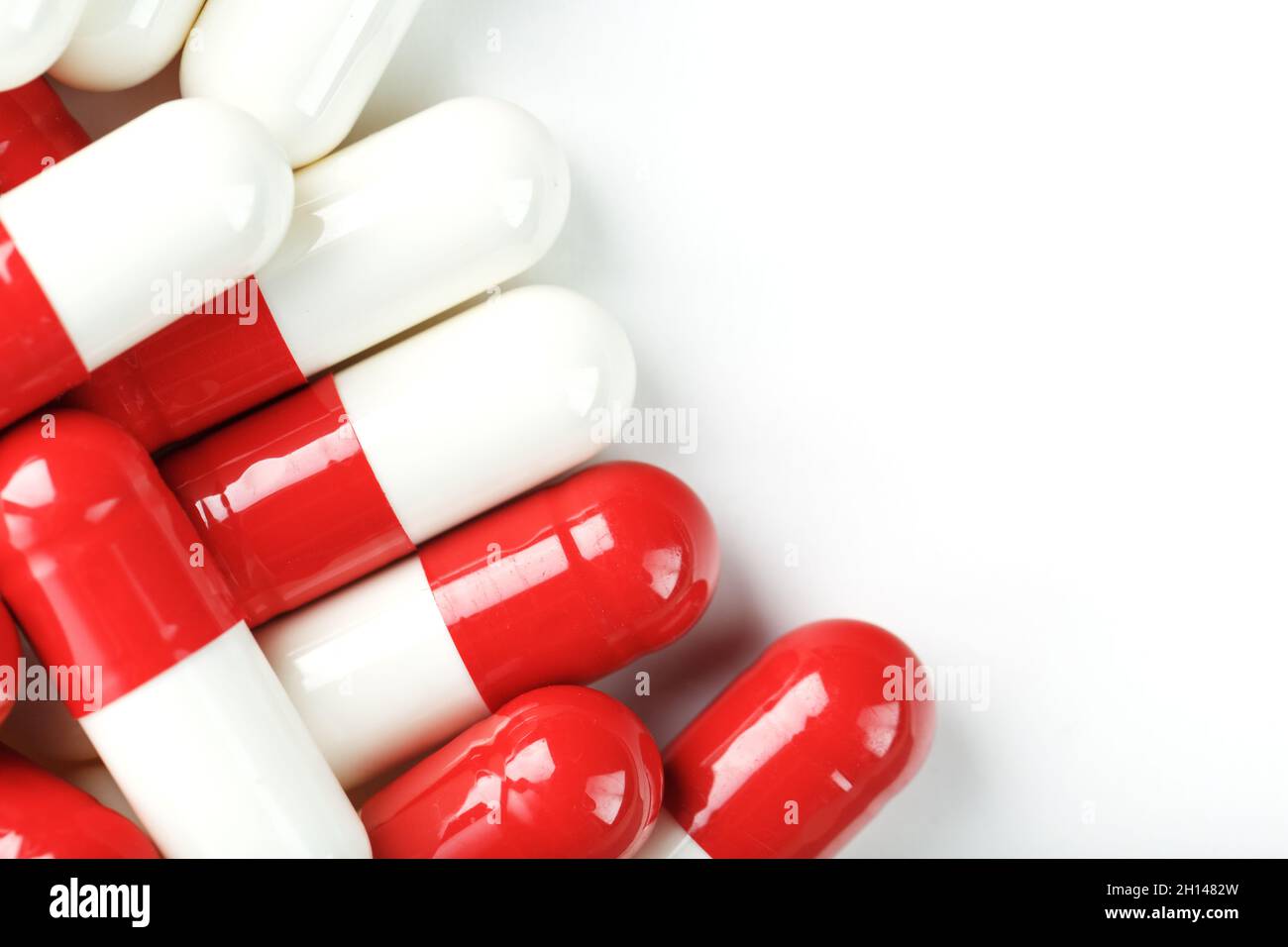 Red and white tablets on a white background with free space. Top view ...