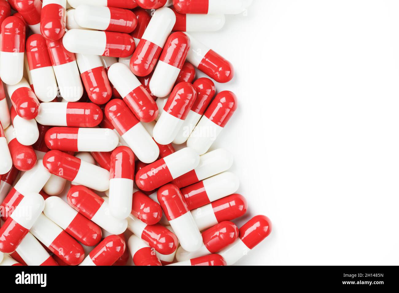 Red and white tablets on a white background with free space. Top view ...
