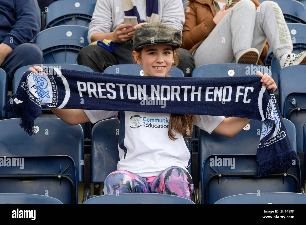 A Preston North End fan wears a flat cap in tribute to the recent ...