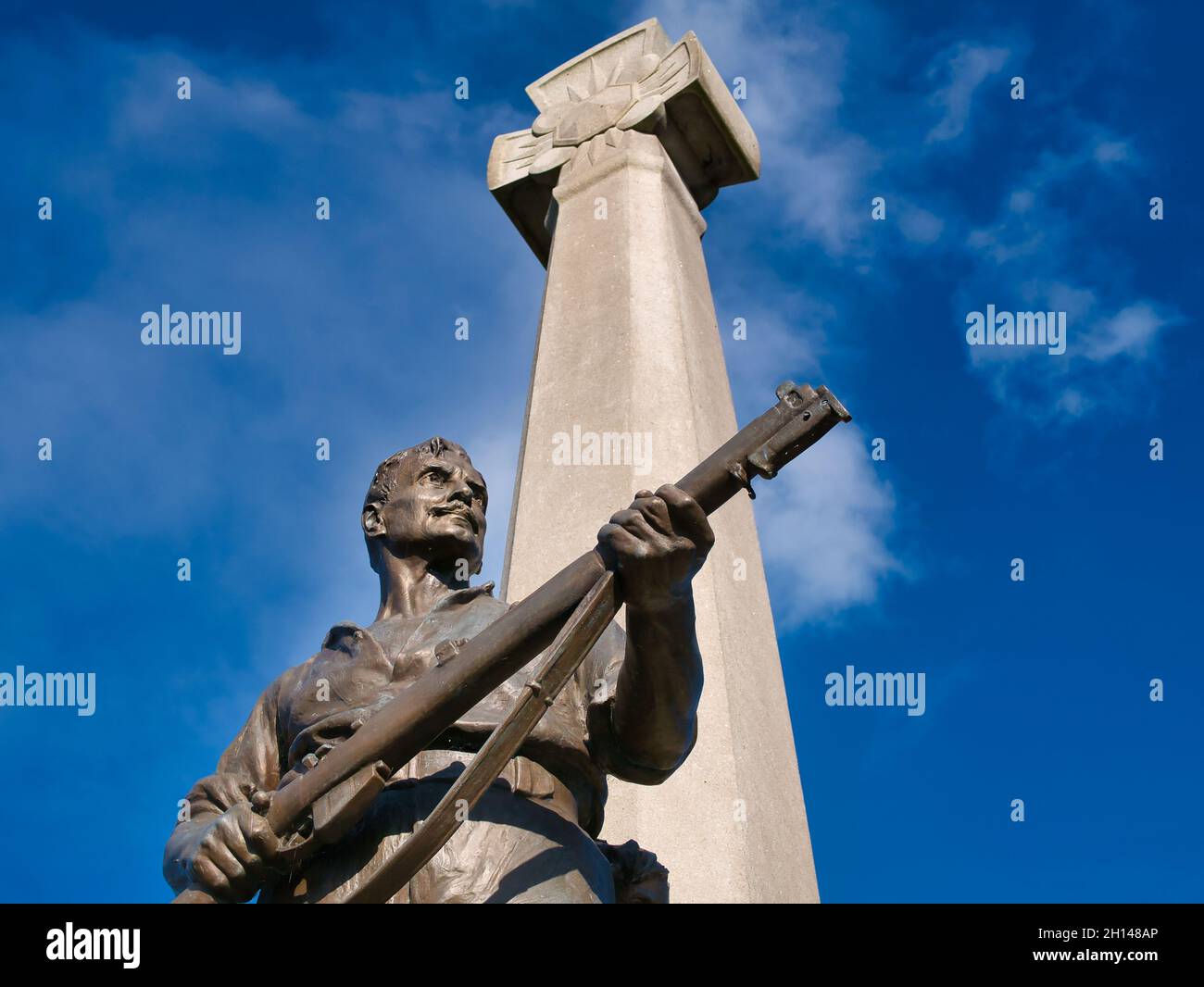 The bronze figure of a soldier and rifle with runic cross behind from ...