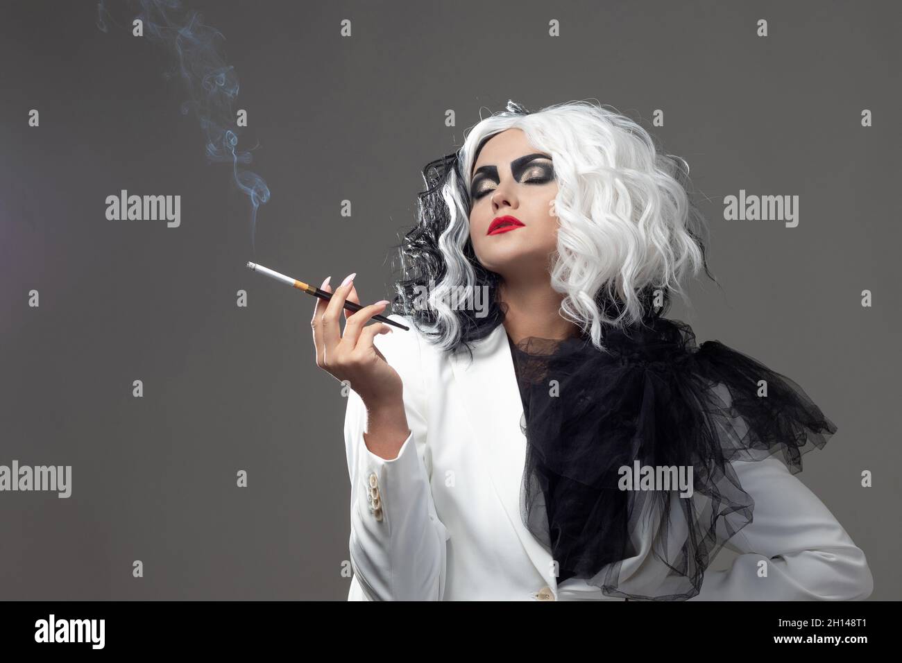 A charismatic unusual woman in a black and white outfit with black and ...