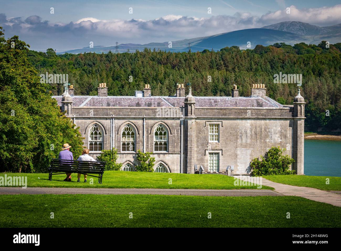 A couple admiring Plas Newydd, a stately home in Anglesey, Wales Stock ...
