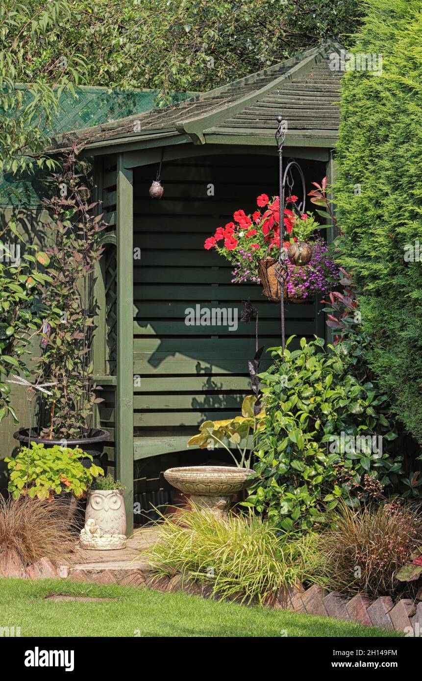 English back Garden with Gazebo seating area with hanging flower basket ...
