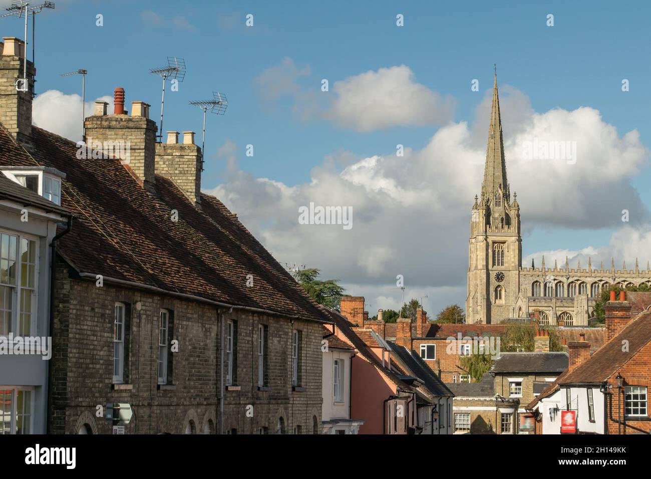 Facade of old terraced cottage brick houses with Cathedral tower ...