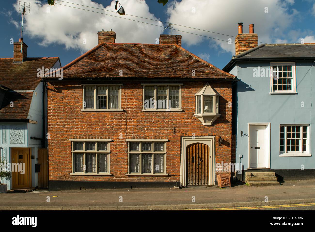 Facade of old British brick house with medieval gate at Saffron Walden ...