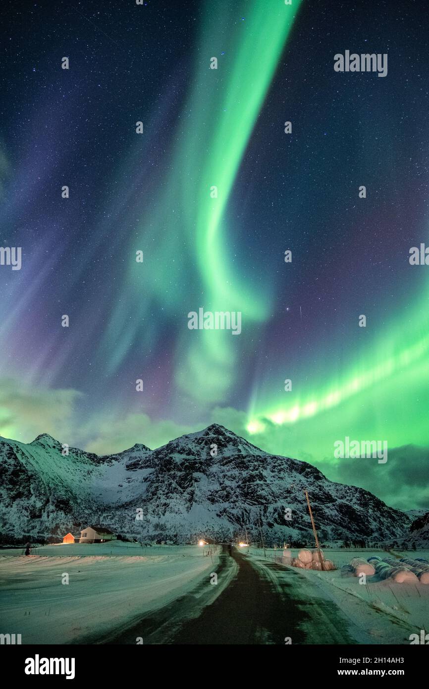 Aurora Borealis, Northern Lights explosion over snow mountain and road ...