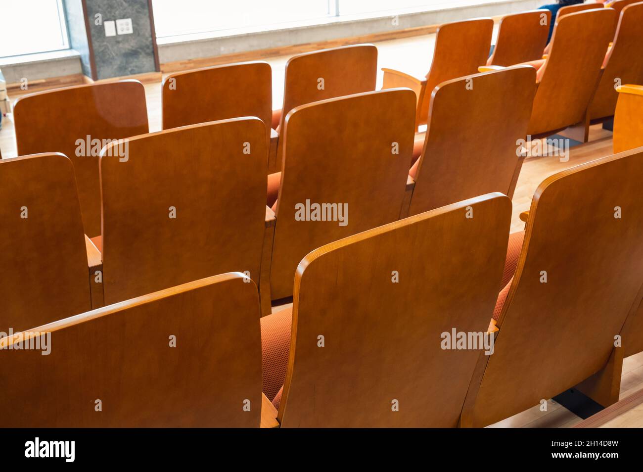 Rear of row brown theatre seats in auditorium hall Stock Photo - Alamy