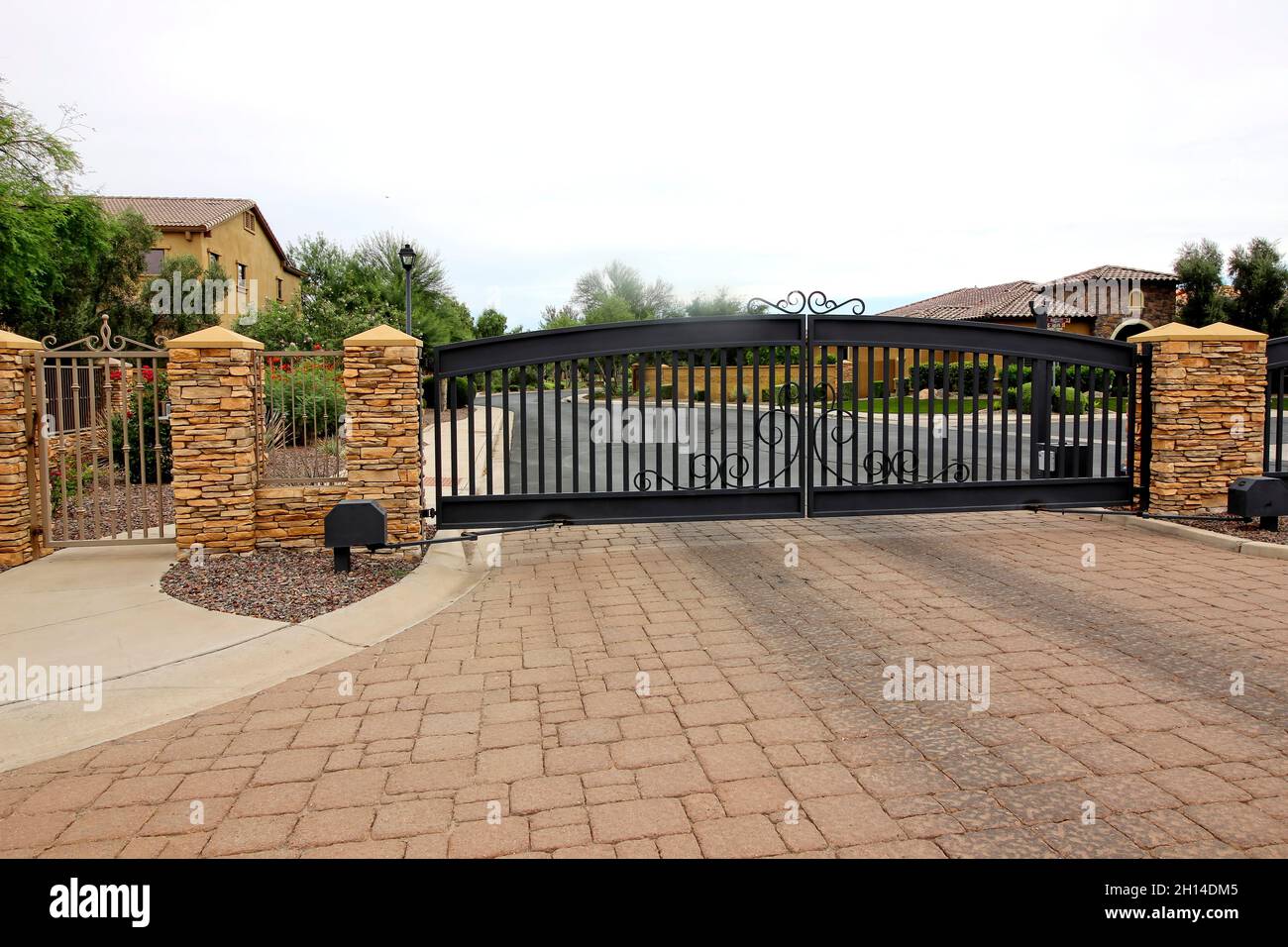 Electric Exit Gate On Pavers With Walk In Entrance Stock Photo - Alamy