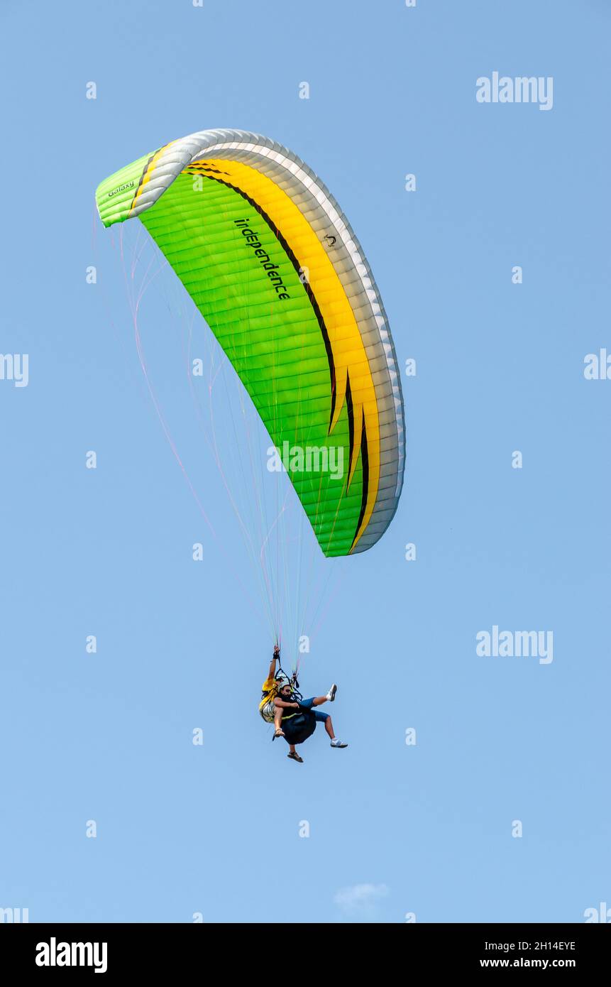 Tandem green and yellow-colored parachute against clear blue sky Stock ...