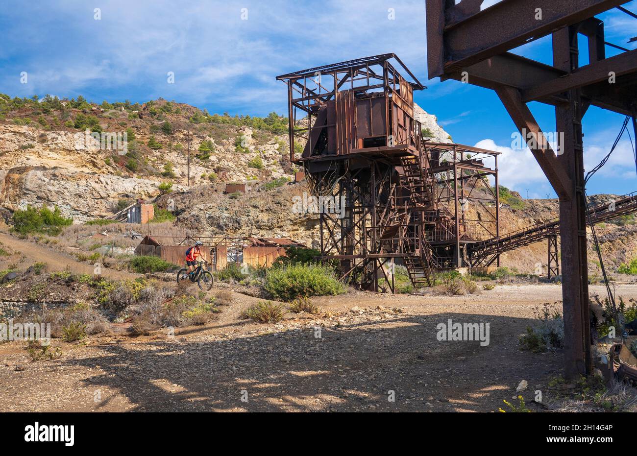 nice active woman riding her electric mountain bike in the abandoned ...