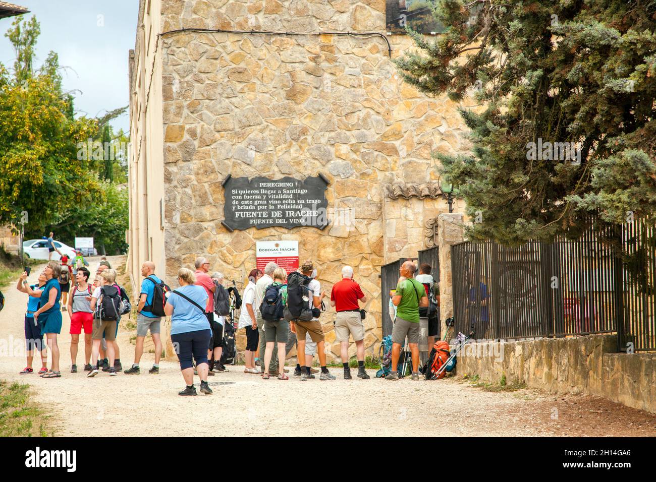 Pilgrims queuing at wine fountain at the Bodegas Irache at Ayegui Navarra while walking the ...
