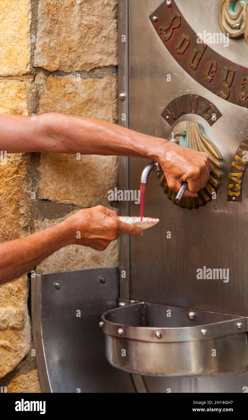 Pilgrims using the wine fountain at the Bodegas Irache at Ayegui ...