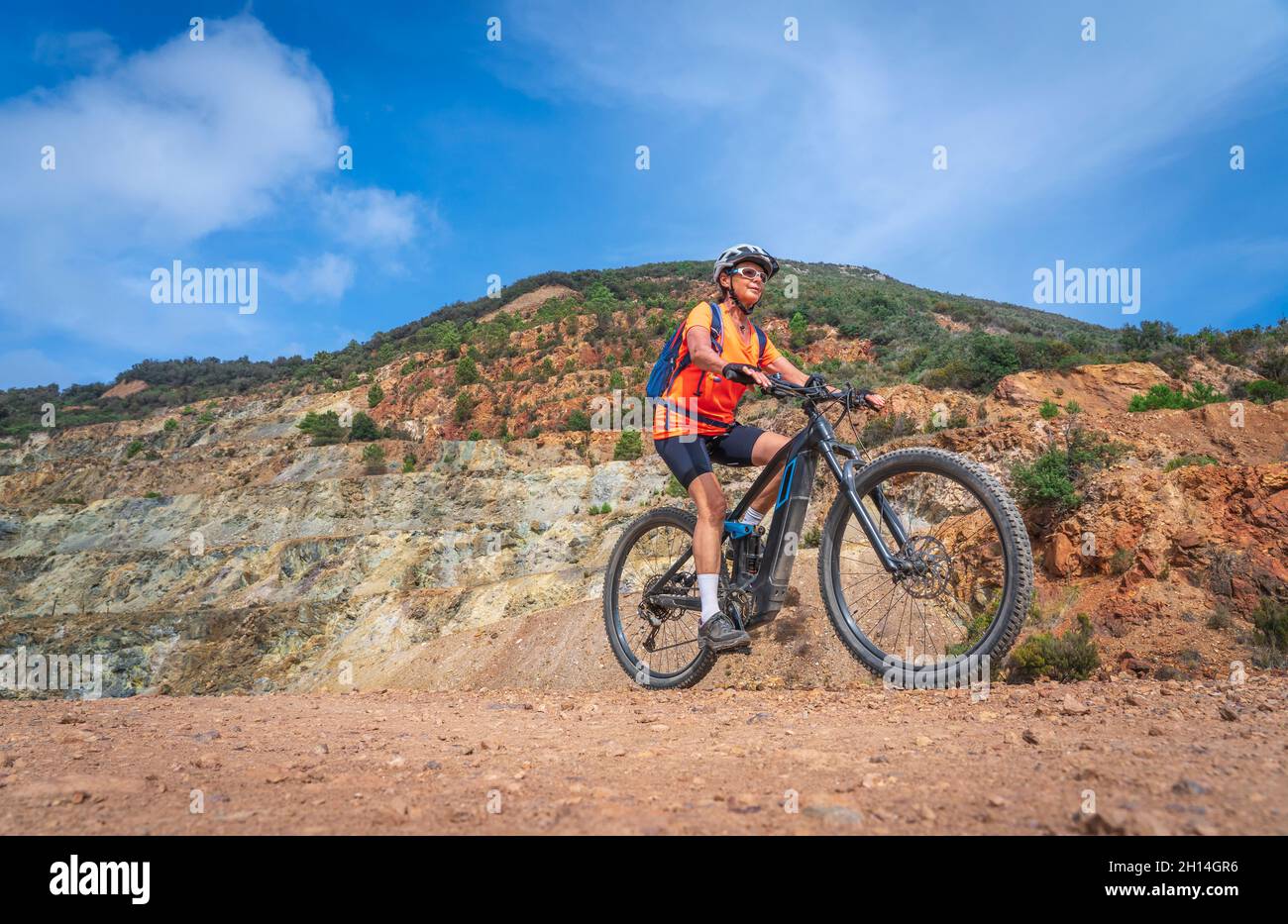nice active woman riding her electric mountain bike in the abandoned ...