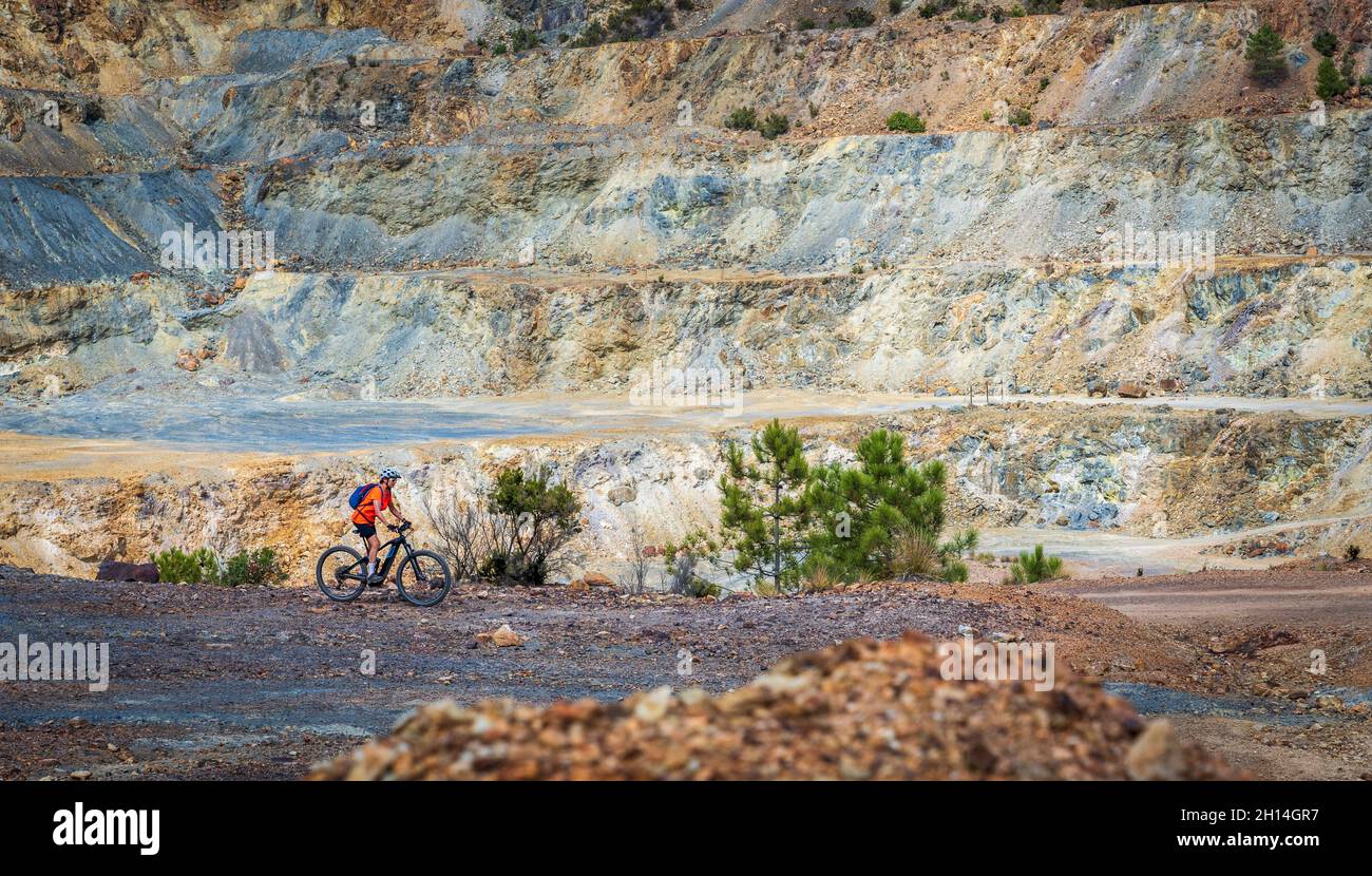 nice active woman riding her electric mountain bike in the abandoned ...