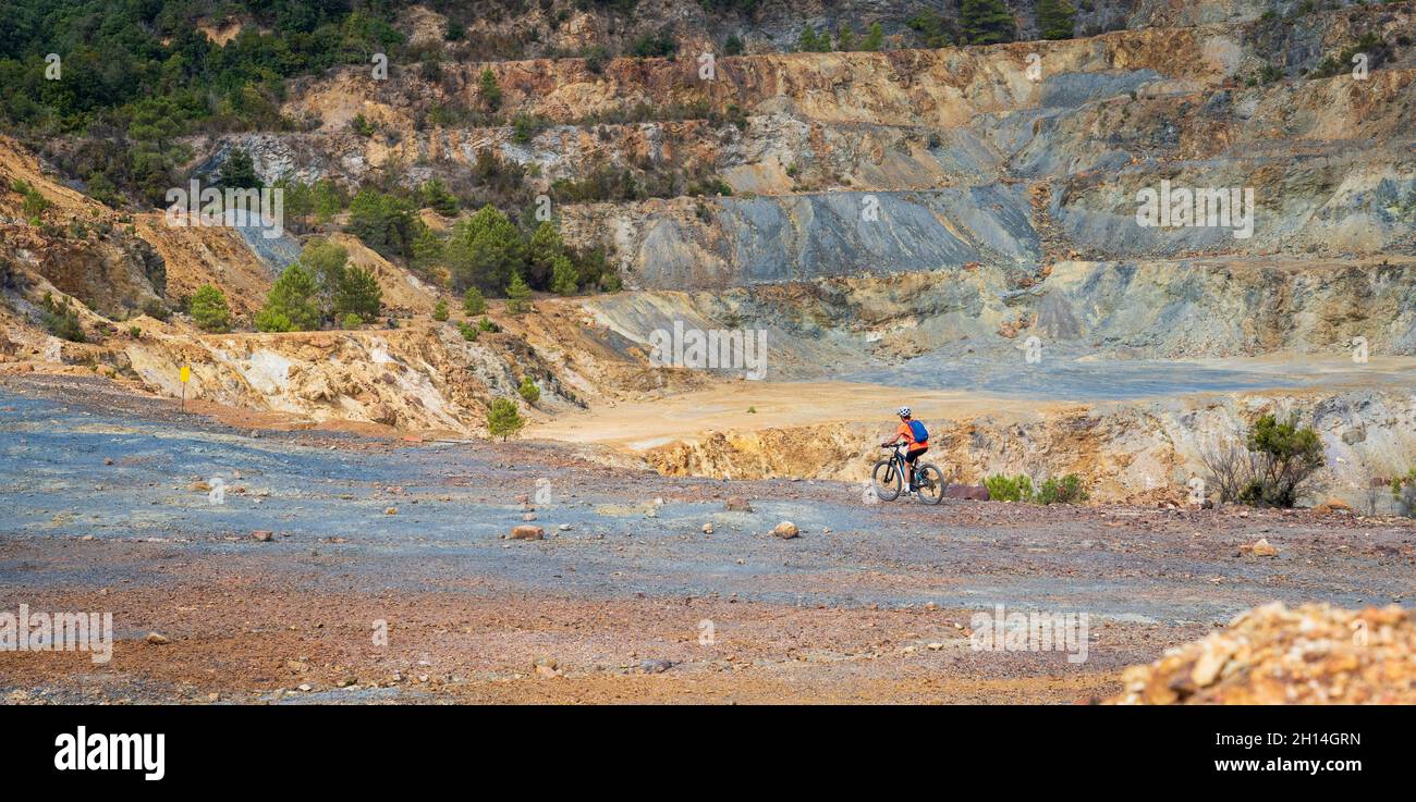 nice active woman riding her electric mountain bike in the abandoned ...