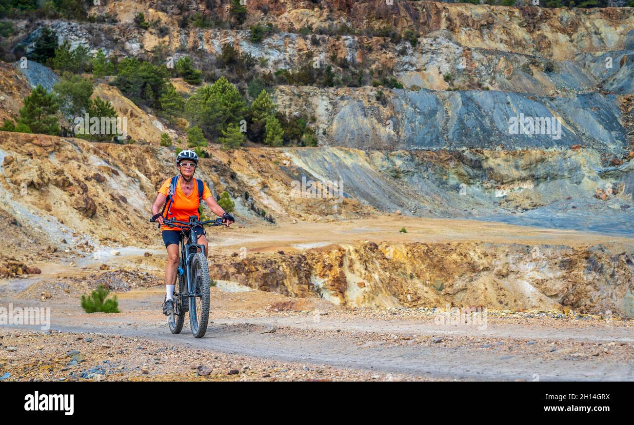 nice active woman riding her electric mountain bike in the abandoned ...