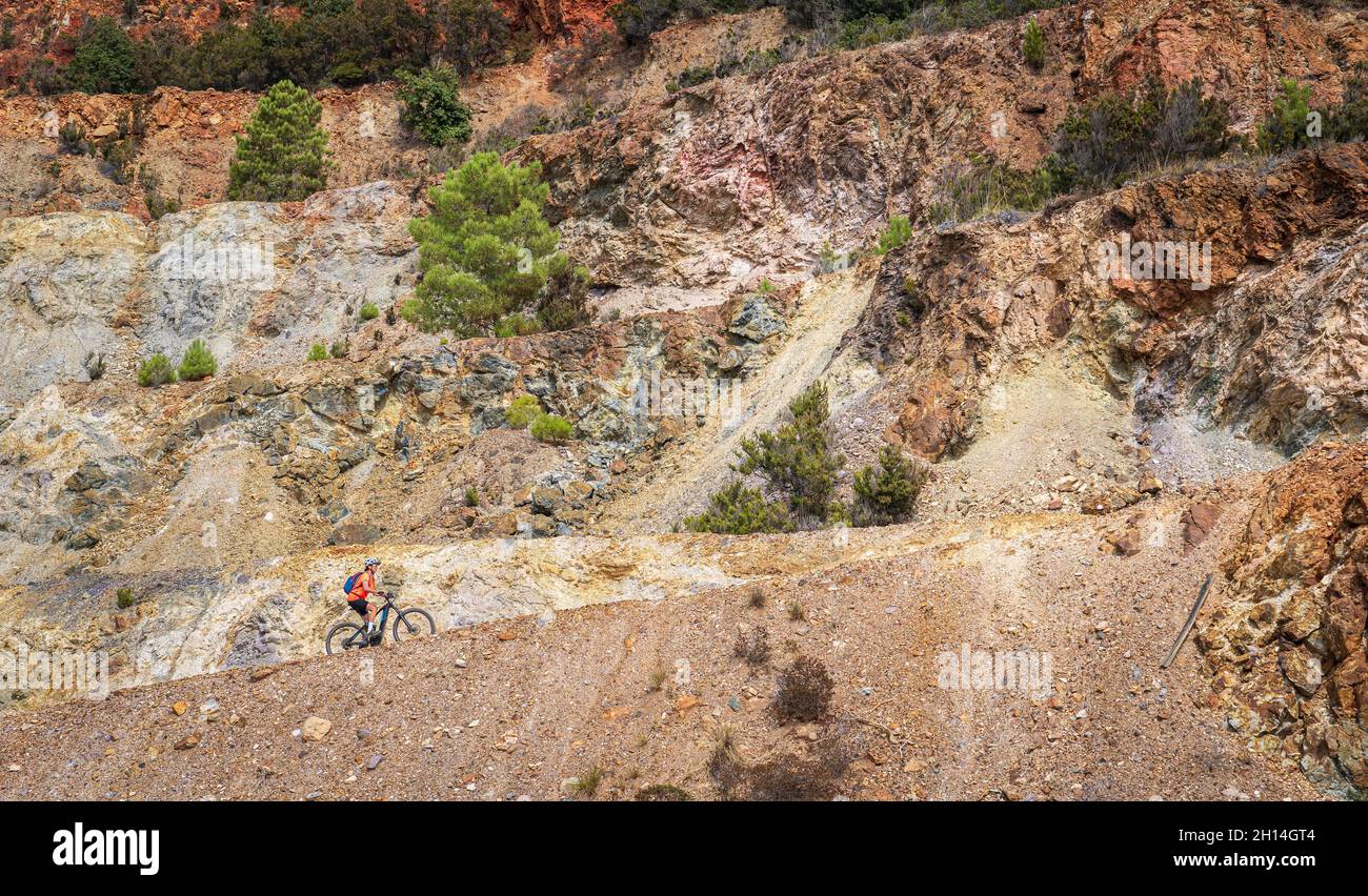 nice active woman riding her electric mountain bike in the abandoned ...
