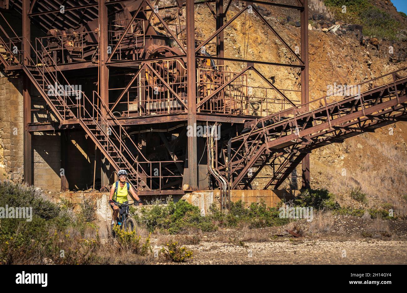 nice active woman riding her electric mountain bike in the abandoned ...