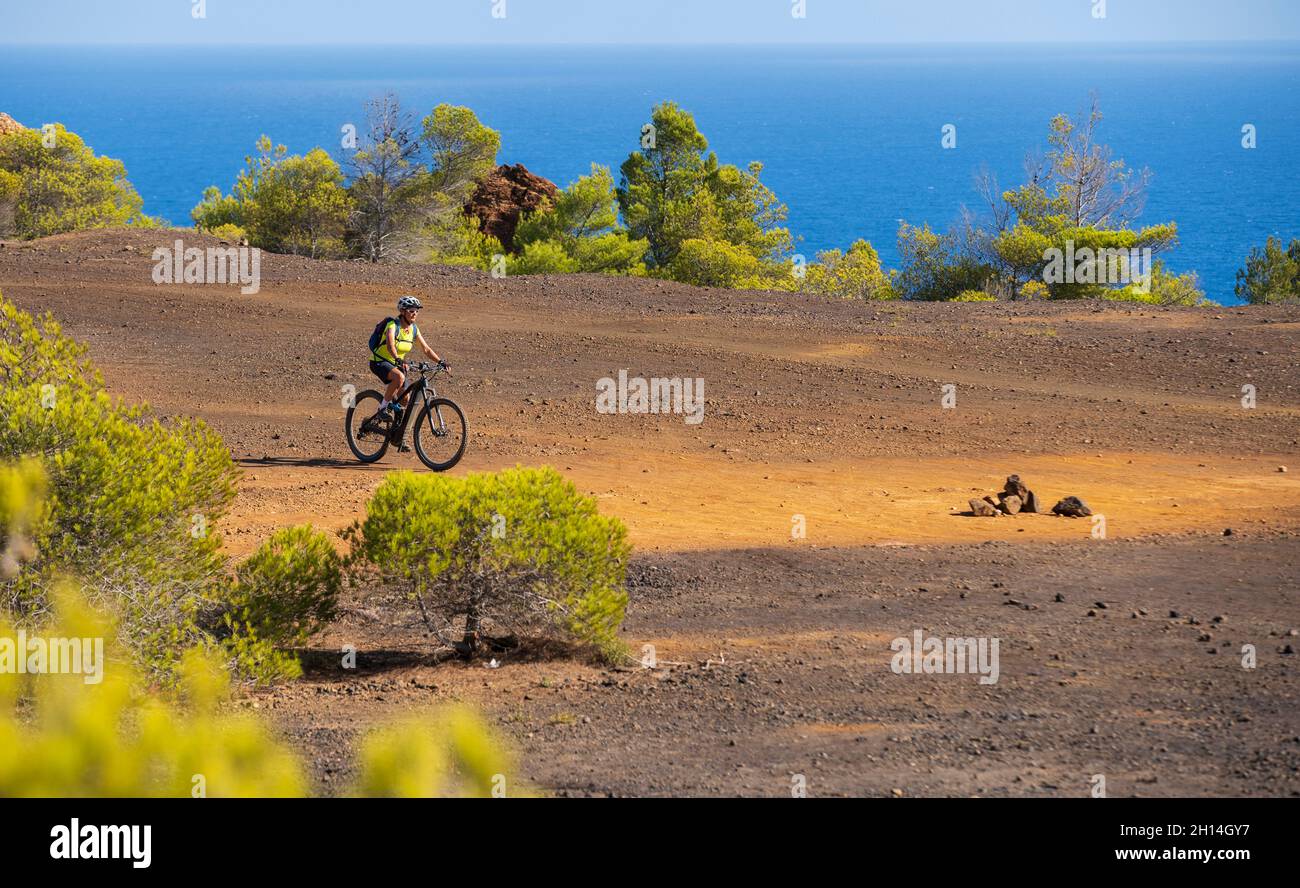 nice active woman riding her electric mountain bike in the abandoned ...