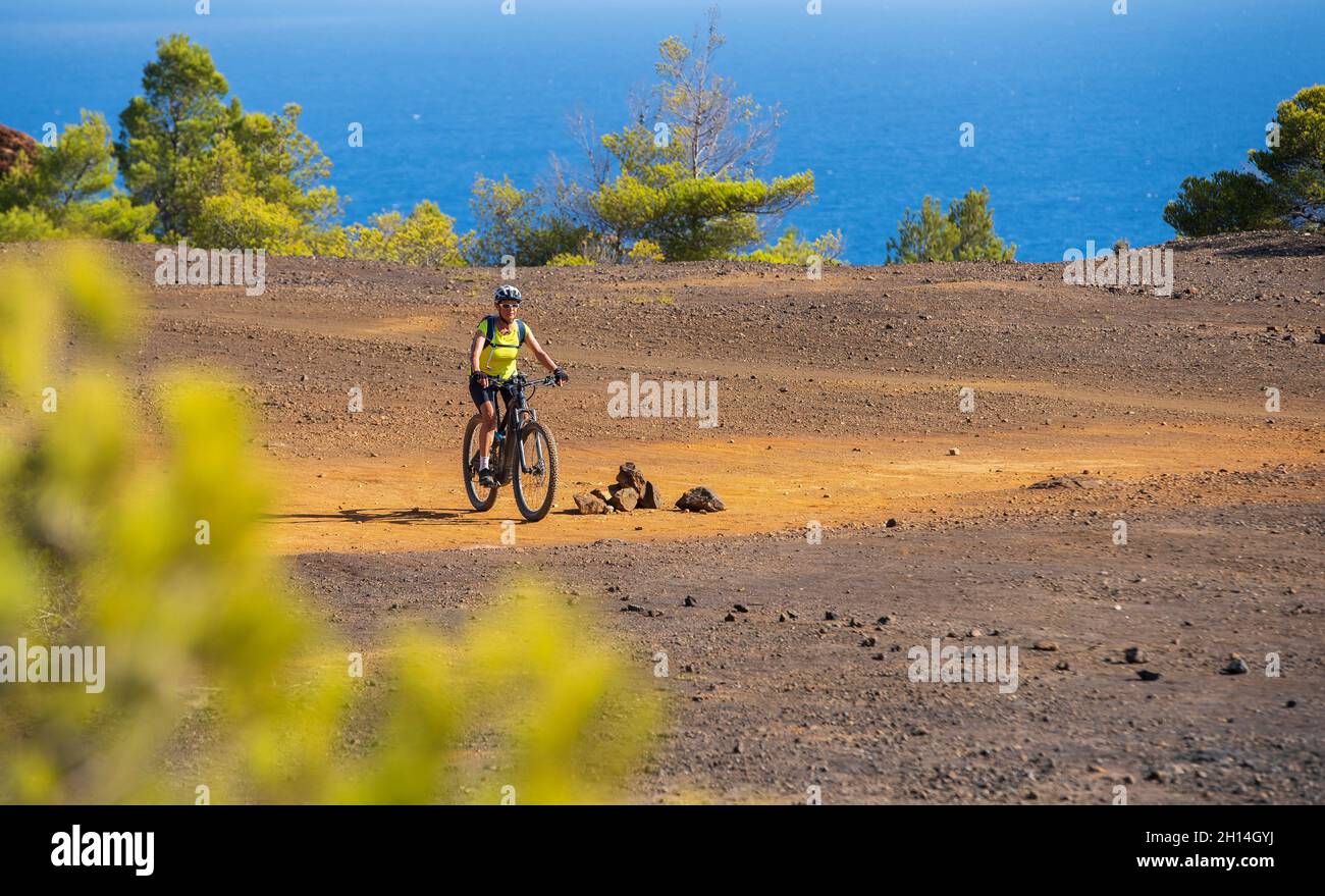 nice active woman riding her electric mountain bike in the abandoned ...