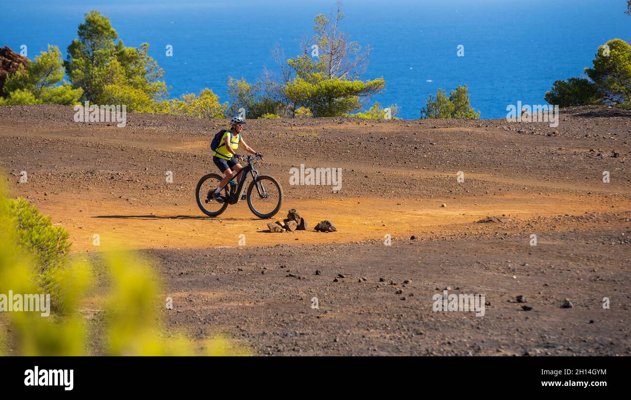 nice active woman riding her electric mountain bike in the abandoned ...