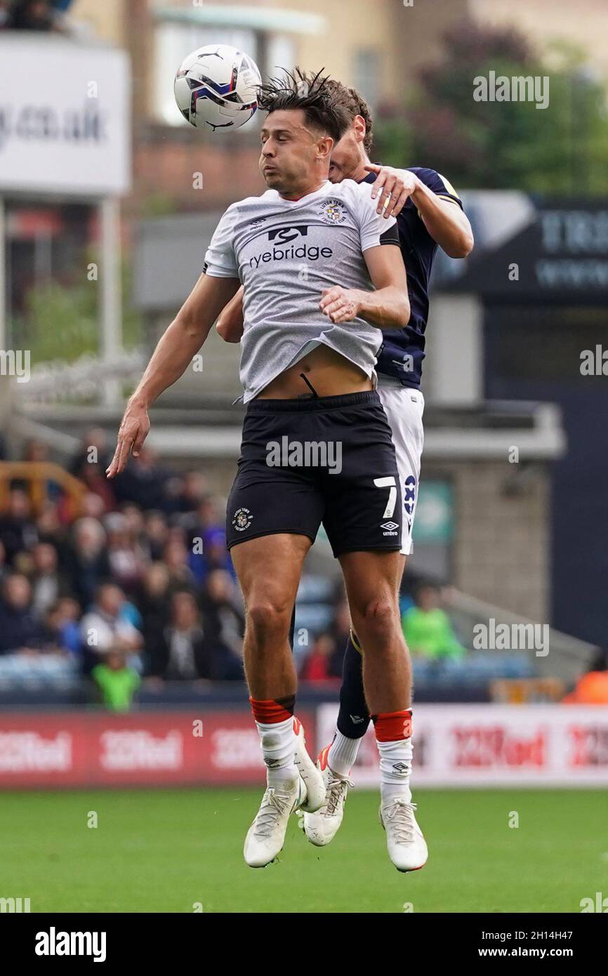 Luton Town's Harry Cornick heads the ball under pressure from Millwall ...