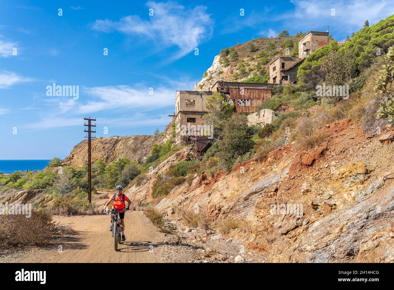 nice active woman riding her electric mountain bike in the abandoned ...