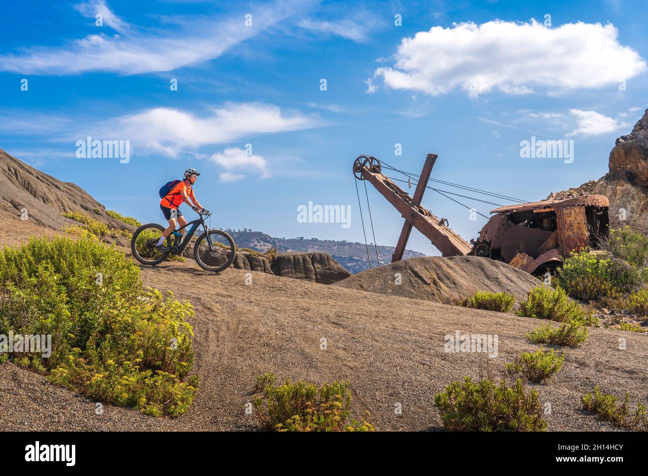 nice active woman riding her electric mountain bike in the abandoned ...