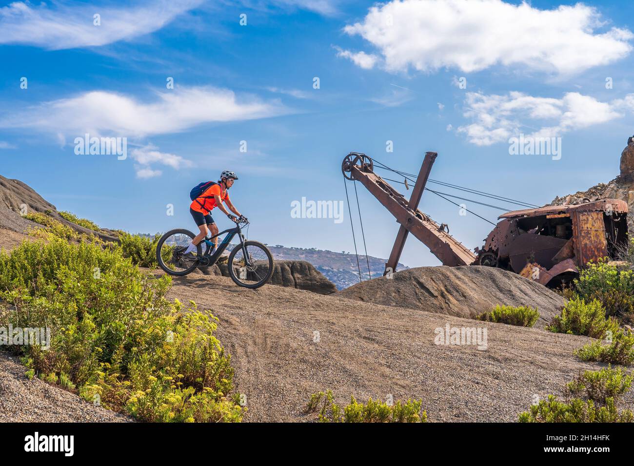 nice active woman riding her electric mountain bike in the abandoned ...
