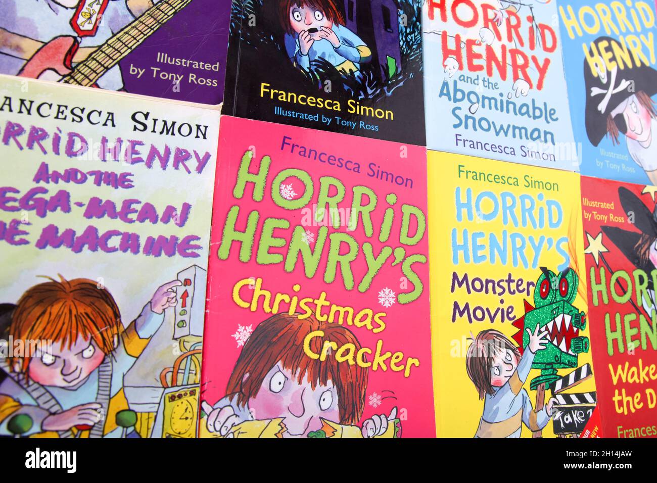 A selection of Horrid Henry books by Francesca Simon arranged on table ...