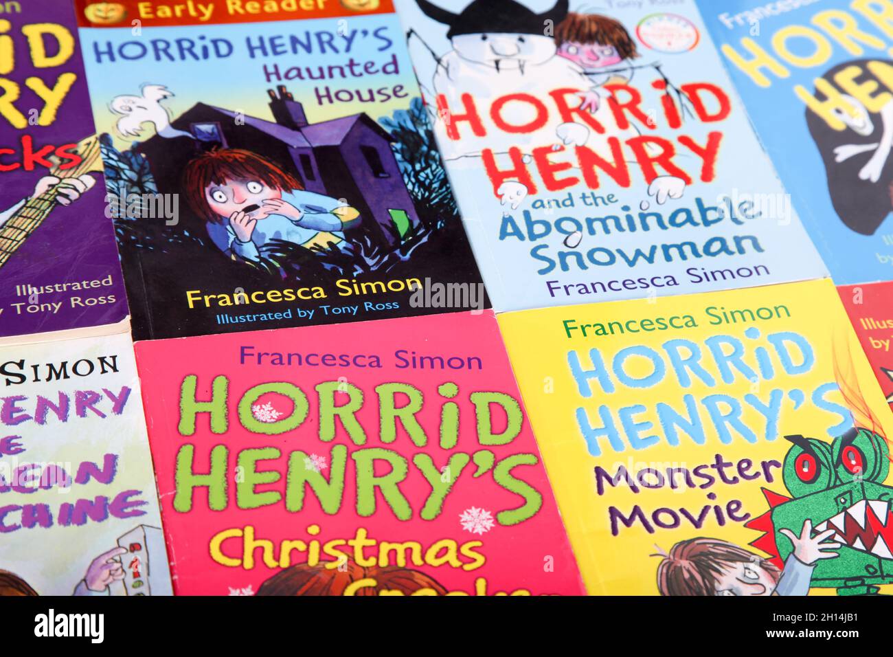 A selection of Horrid Henry books by Francesca Simon arranged on table ...