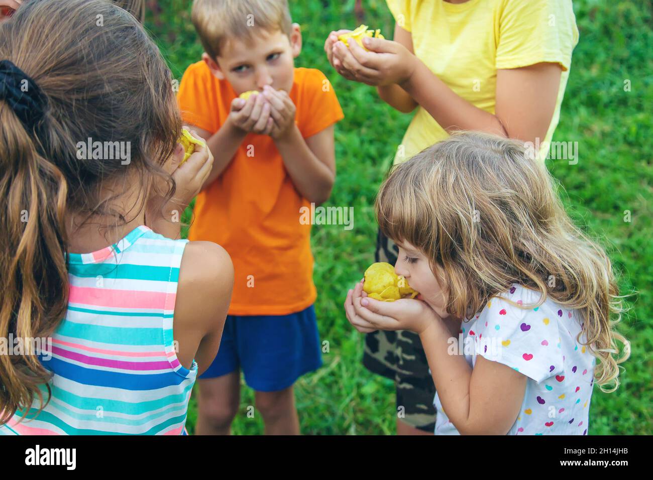 Children eat chips on the street. Selective focus. Food Stock Photo - Alamy