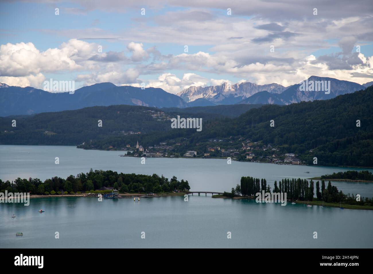 Woerth lake with a mountainscape in the background, Klagenfurt-Land in ... Woerth lake with a mountainscape in the background, Klagenfurt-Land in ...