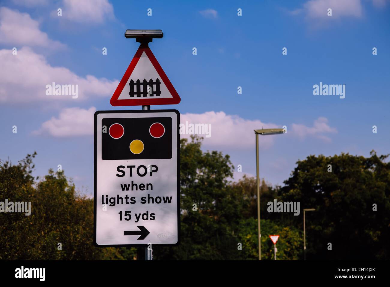 Railway Crossing red triangle warning UK road sign, barriers with ...