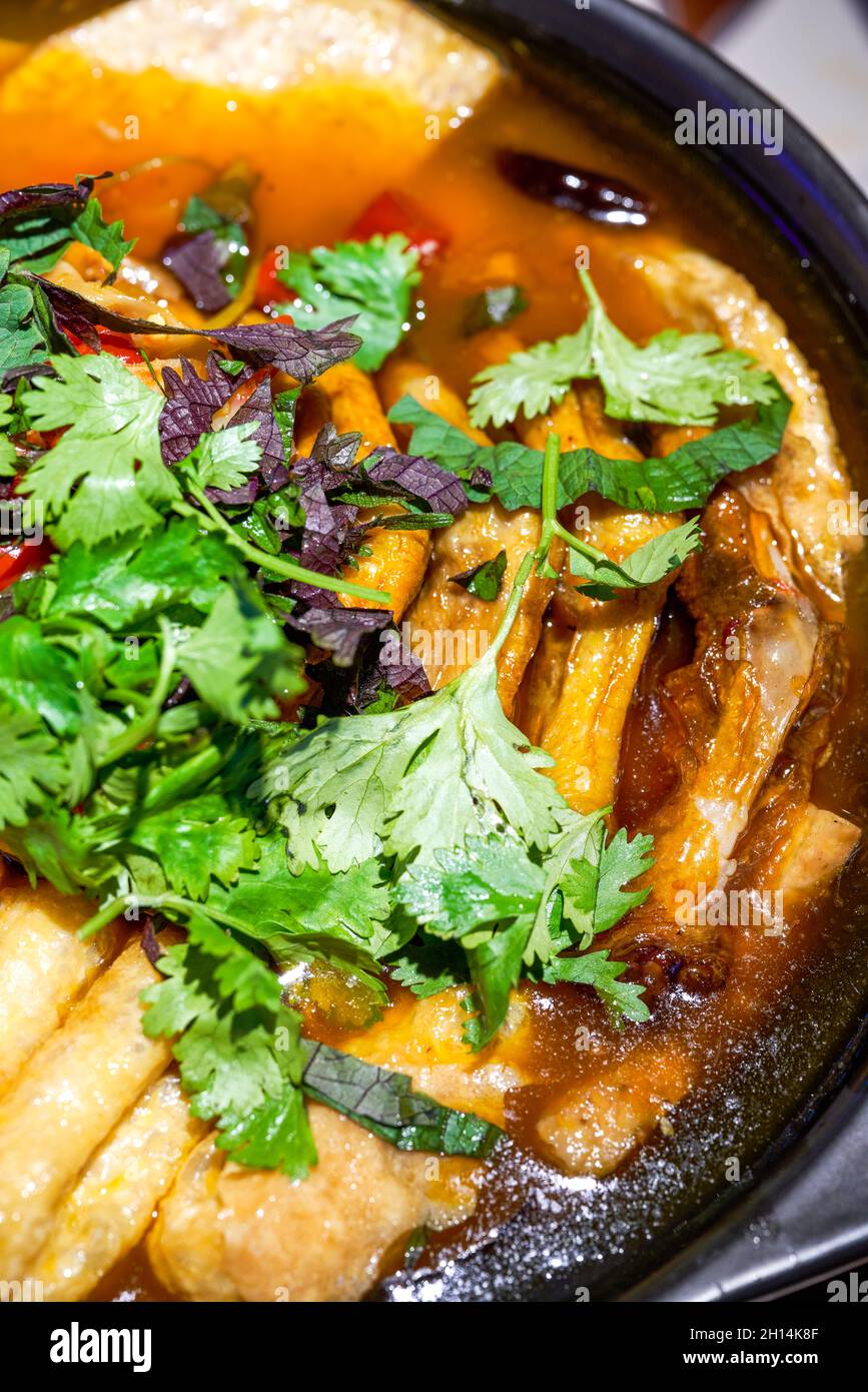 A delicious Chinese Guangxi special dish, snails and duck feet in clay ...