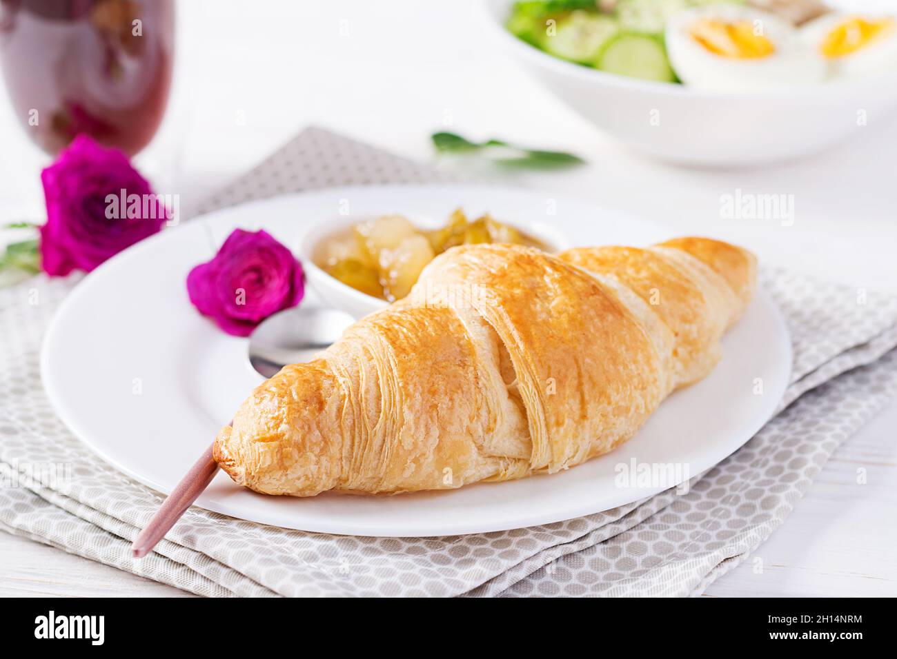 Breakfast oatmeal porridge with boiled egg, cucumber and croissant, jam ...