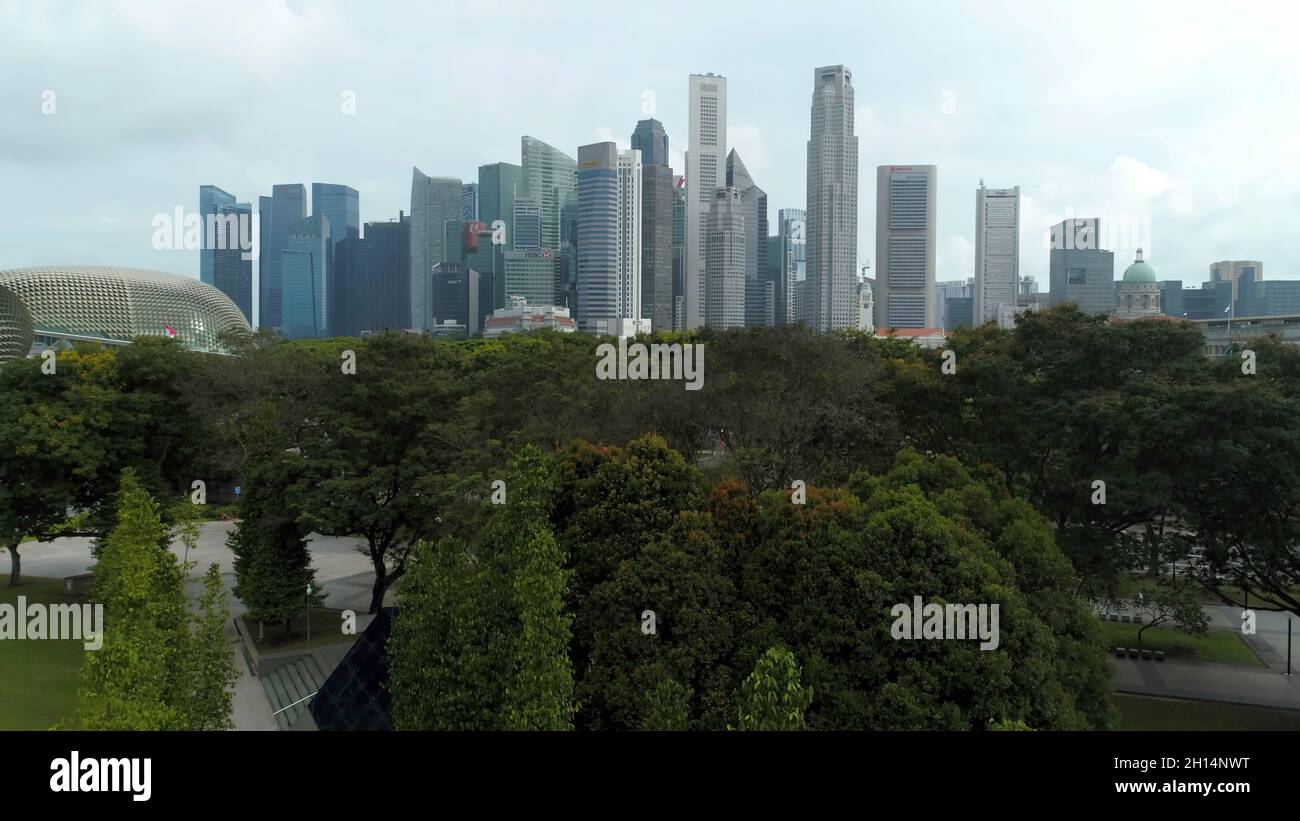 Aerial footage of Singapore skyscrapers with City Skyline during cloudy ...