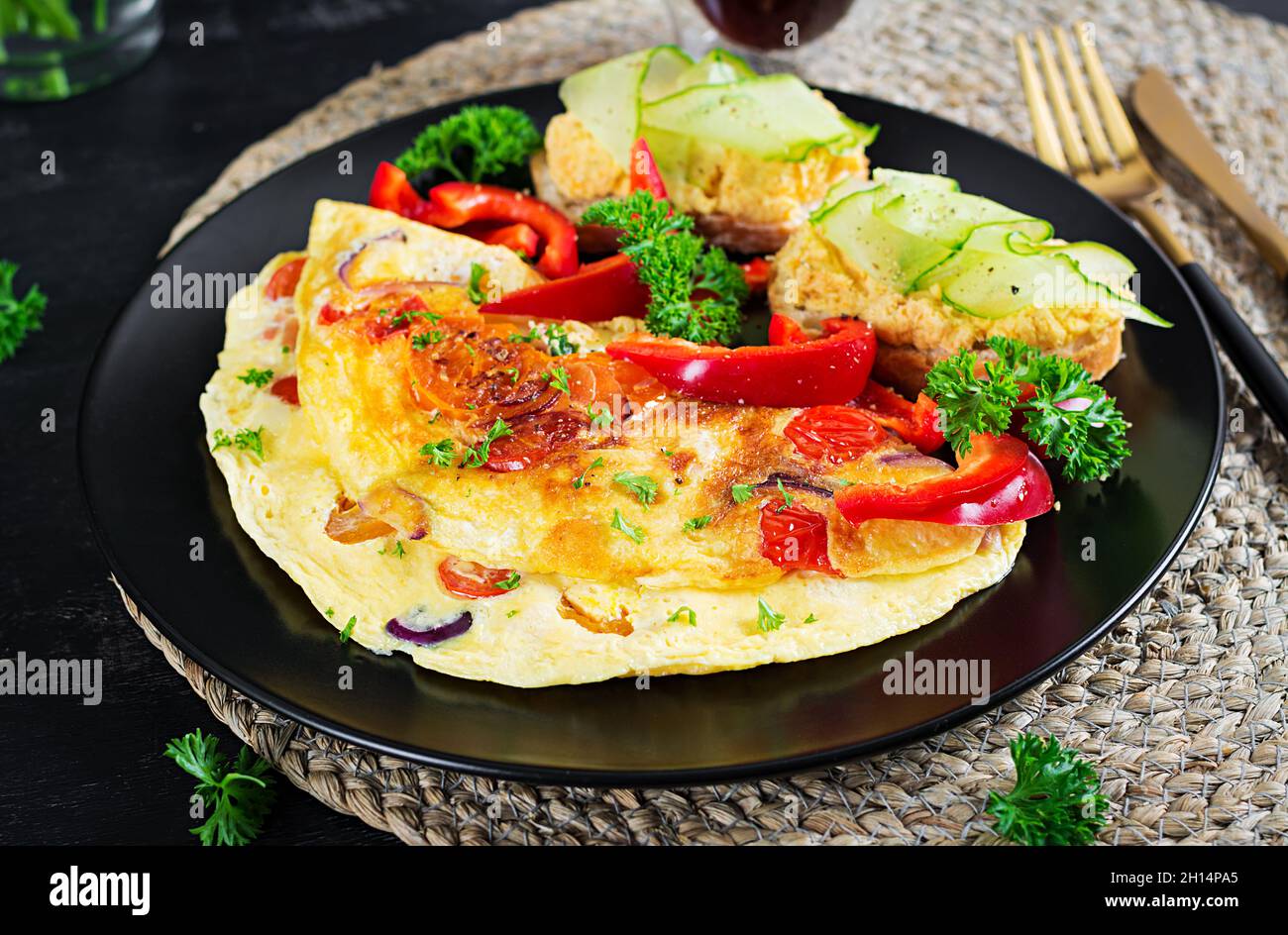 Breakfast. Omelette with paprika, cheese and tomatoes with sandwiches ...