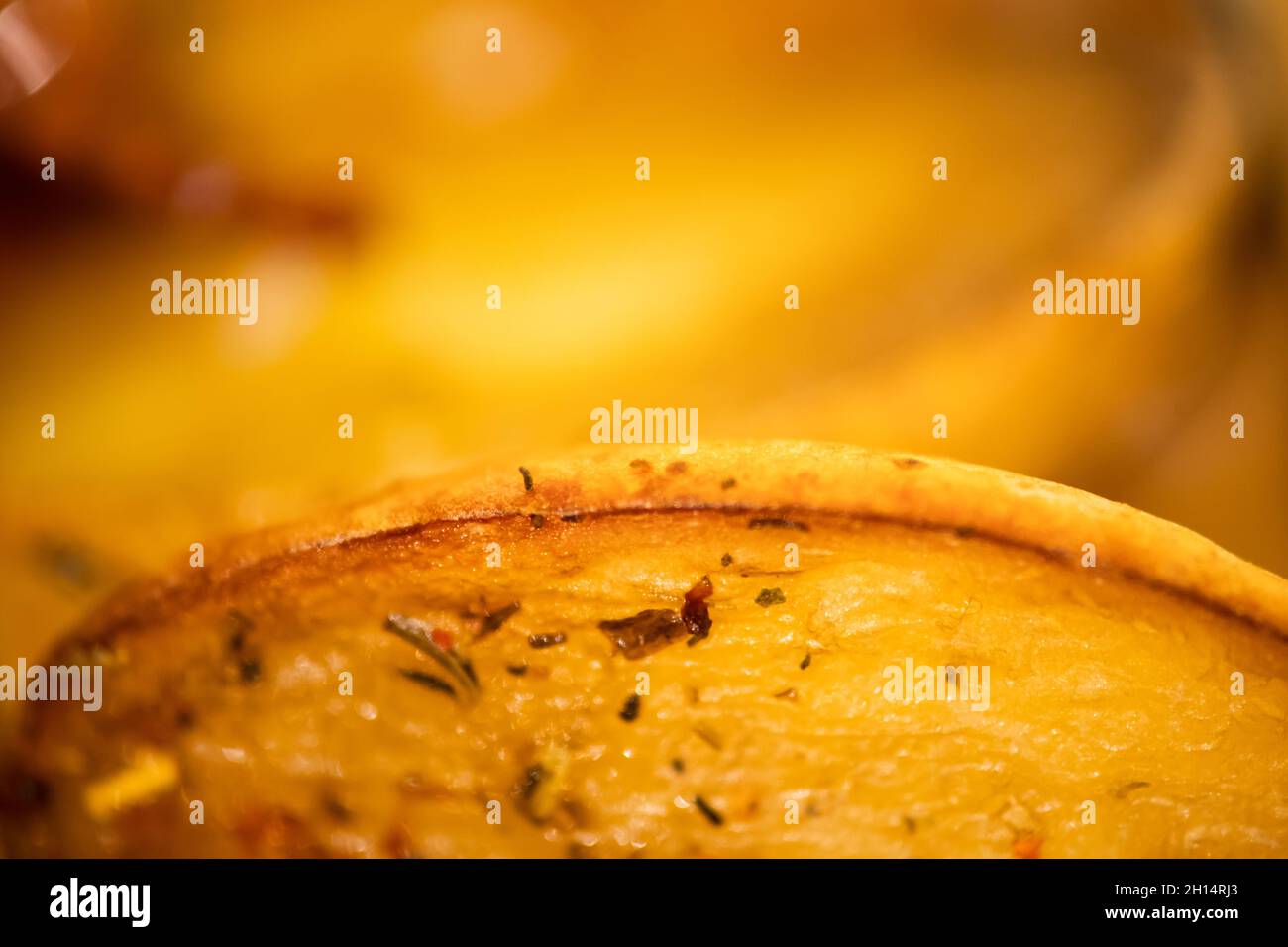 Macro Food: baked potato with Provençal herbs extreme close-up, warm ...