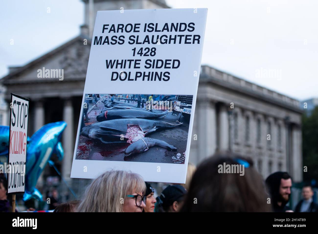 An activist holds a sign during the Stop the Whale and Dolphin ...