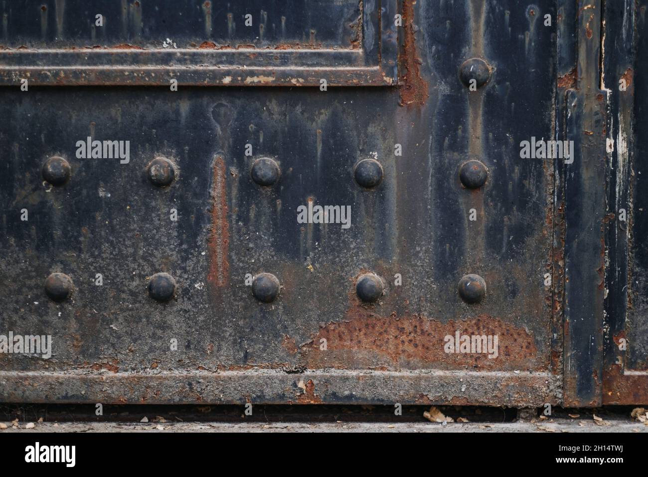 Closeup shot of a rusty black abandoned door surface Stock Photo - Alamy