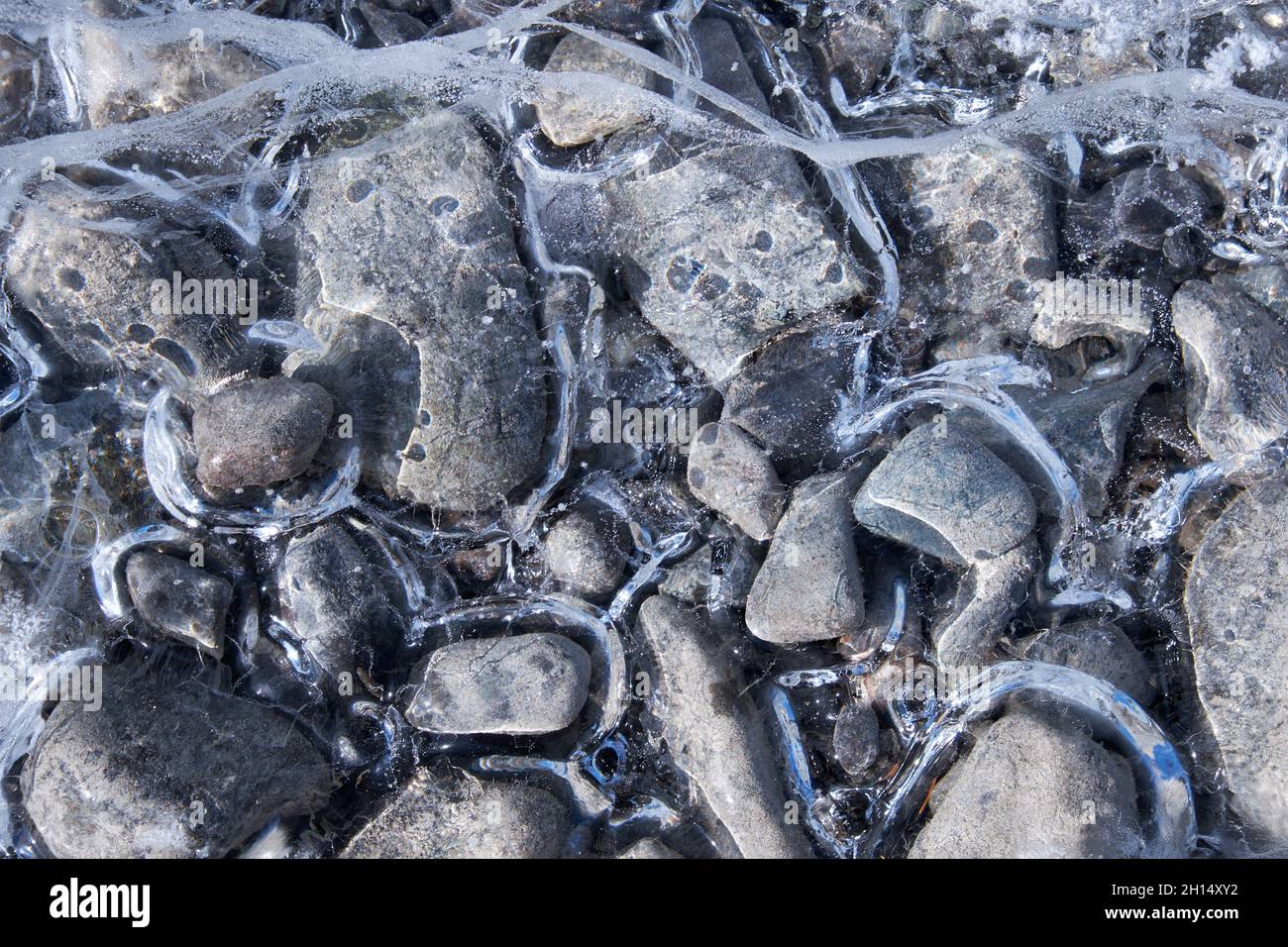 Natural winter background of frozen pebbles and hoarfrost crystals over ...
