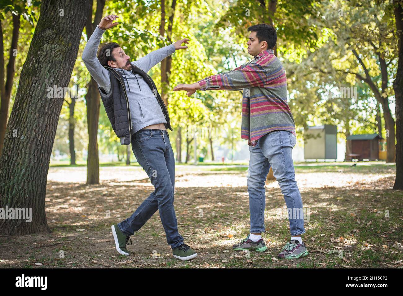 Man pushes another during quarrel. Two very angry, nervous and upset ...