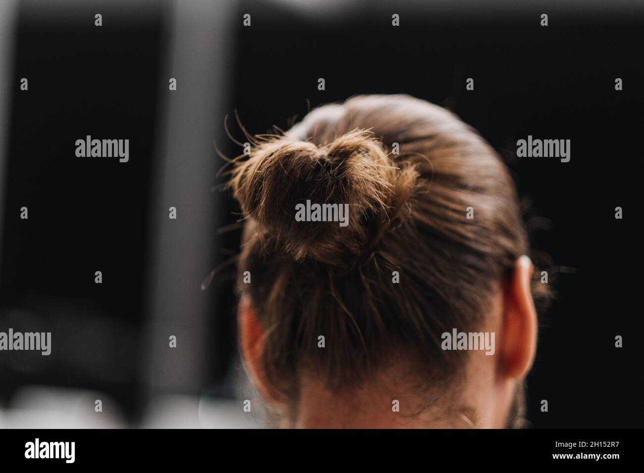 Back view of a brunette female with a bun hairstyle Stock Photo - Alamy