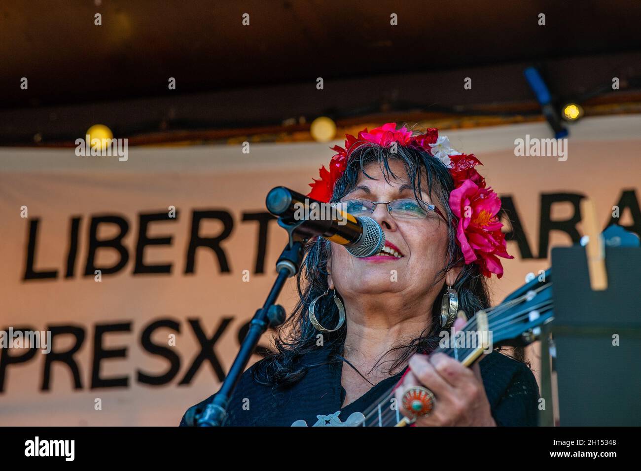 A female musician is seen performing Chilean music while wearing ...