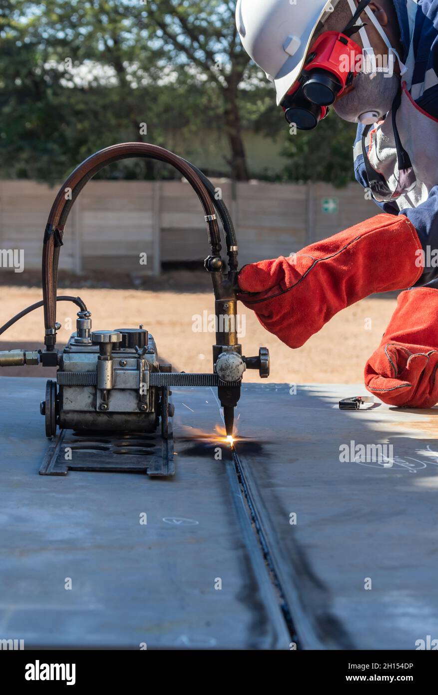 Motswana welder worker in a Botswana workshop, using an acetylene torch ...