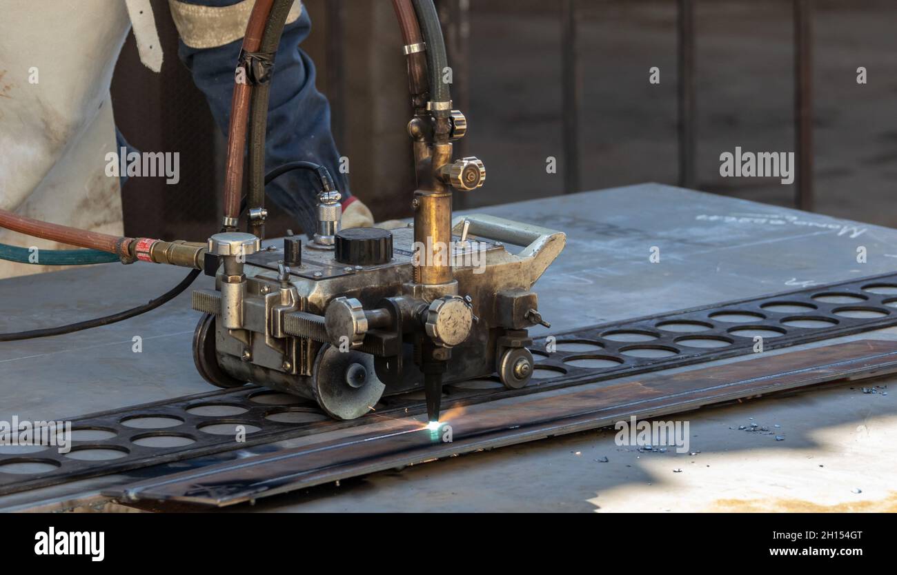 Motswana welder worker in a Botswana workshop, using an acetylene torch ...