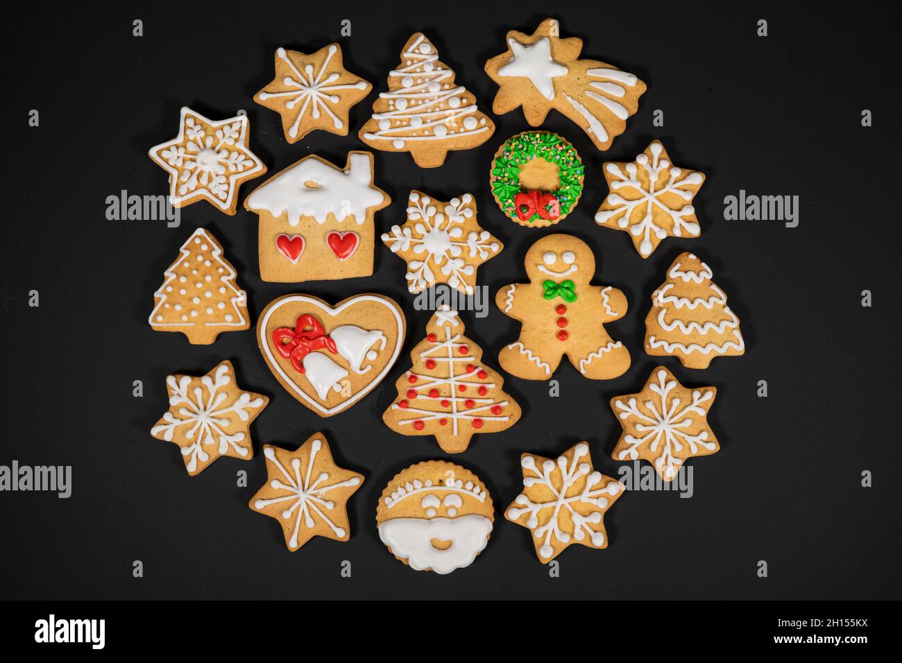 Set of gingerbread cookies in different shapes on a dark surface. Top ...
