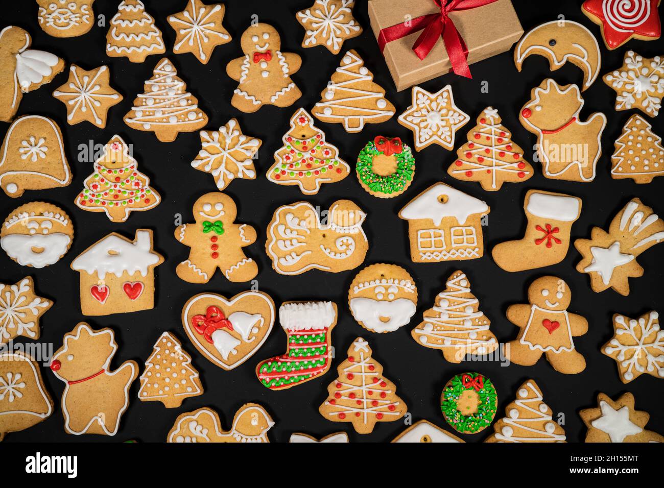 Set of gingerbread cookies in different shapes on a dark surface. Top ...