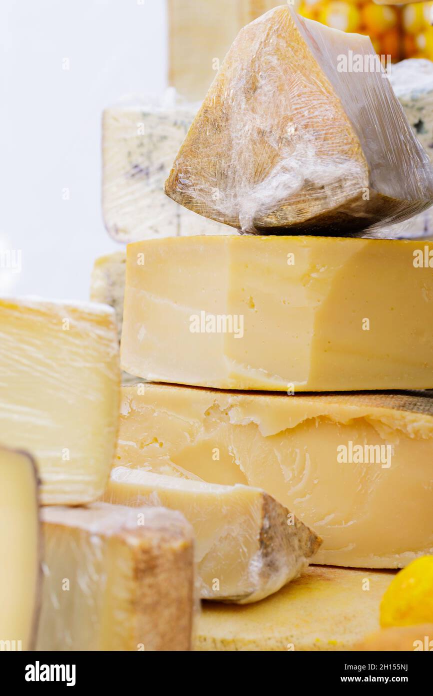 Hard goat cheese on the table. Many varieties of craft cheese are on ...